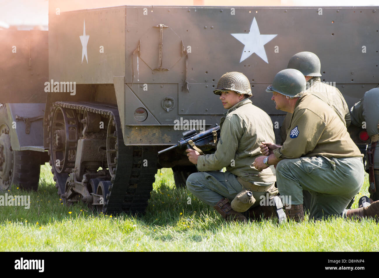 American soldiers take cover behind a Half Track Personnel carrier with ...