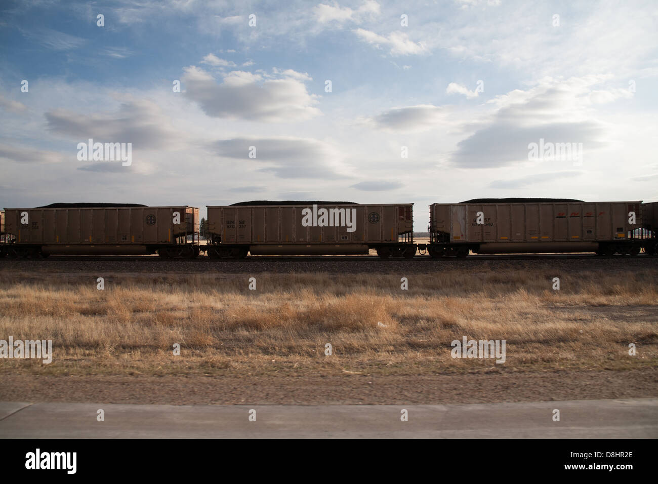 Train box car filled with coal and traveling on train tracks Stock ...