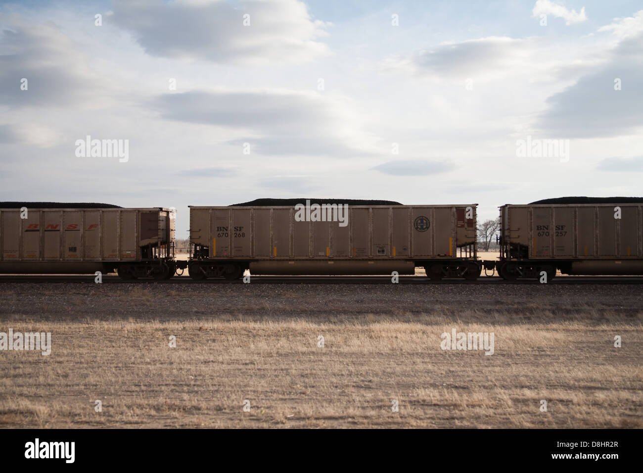 Train box car filled with coal and traveling on train tracks Stock ...