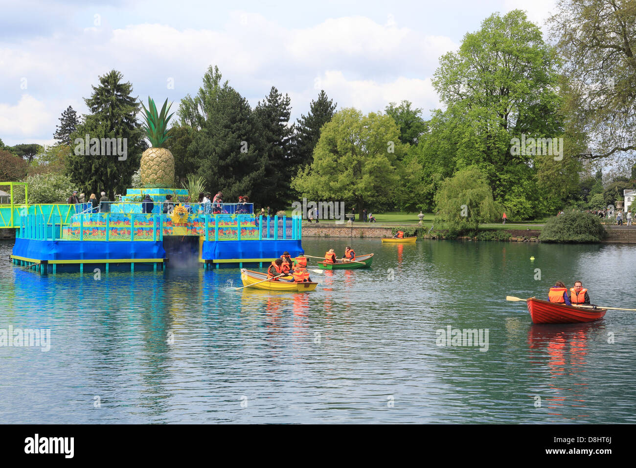 Rowing on the lake in front of the Palm House at Kew Gardens as part of ...