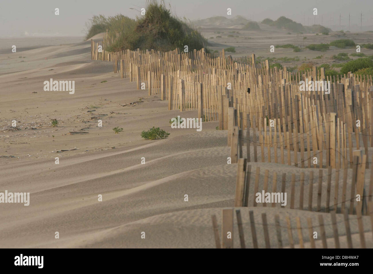 Erosion control measures are seen with a wooden fence installed along a ...