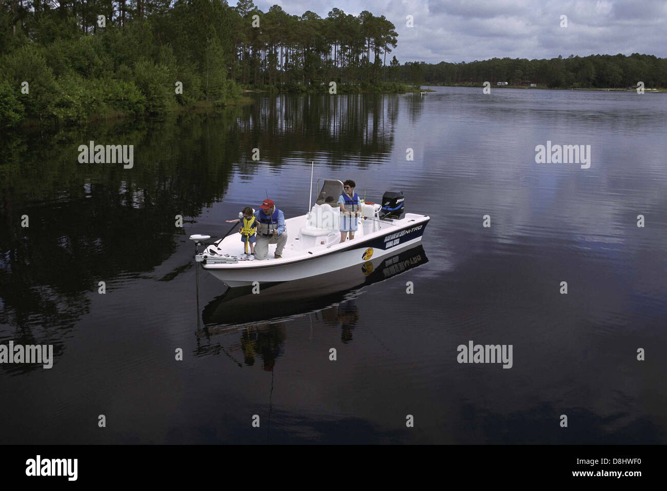 A family is enjoying recreational boating on a lake, spending time ...