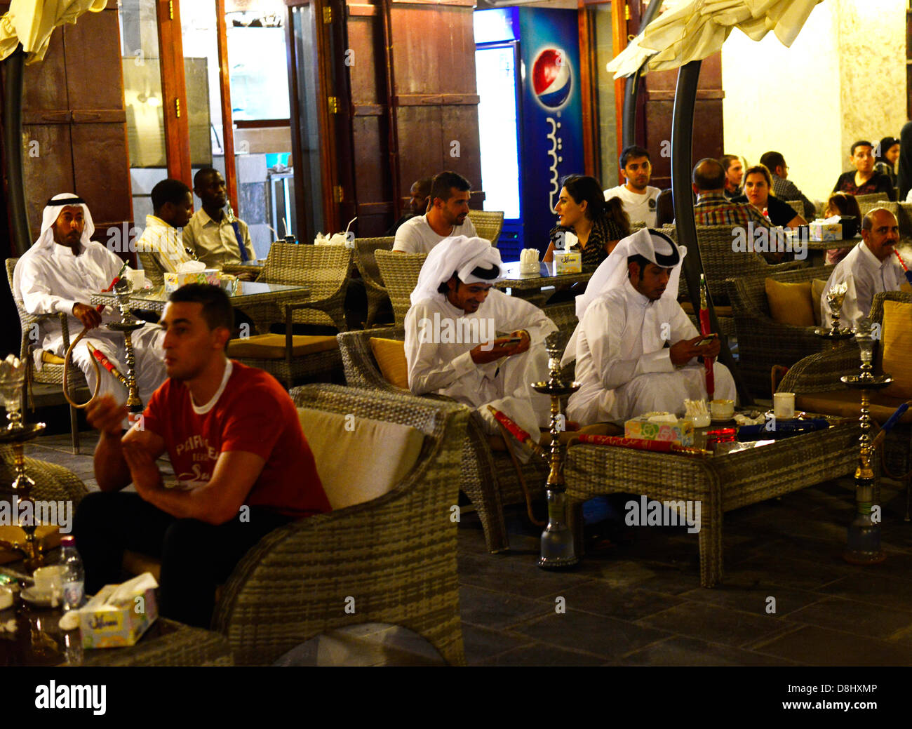 Local Qatari men enjoy Nargila / Shisha in a local coffee house in the ...