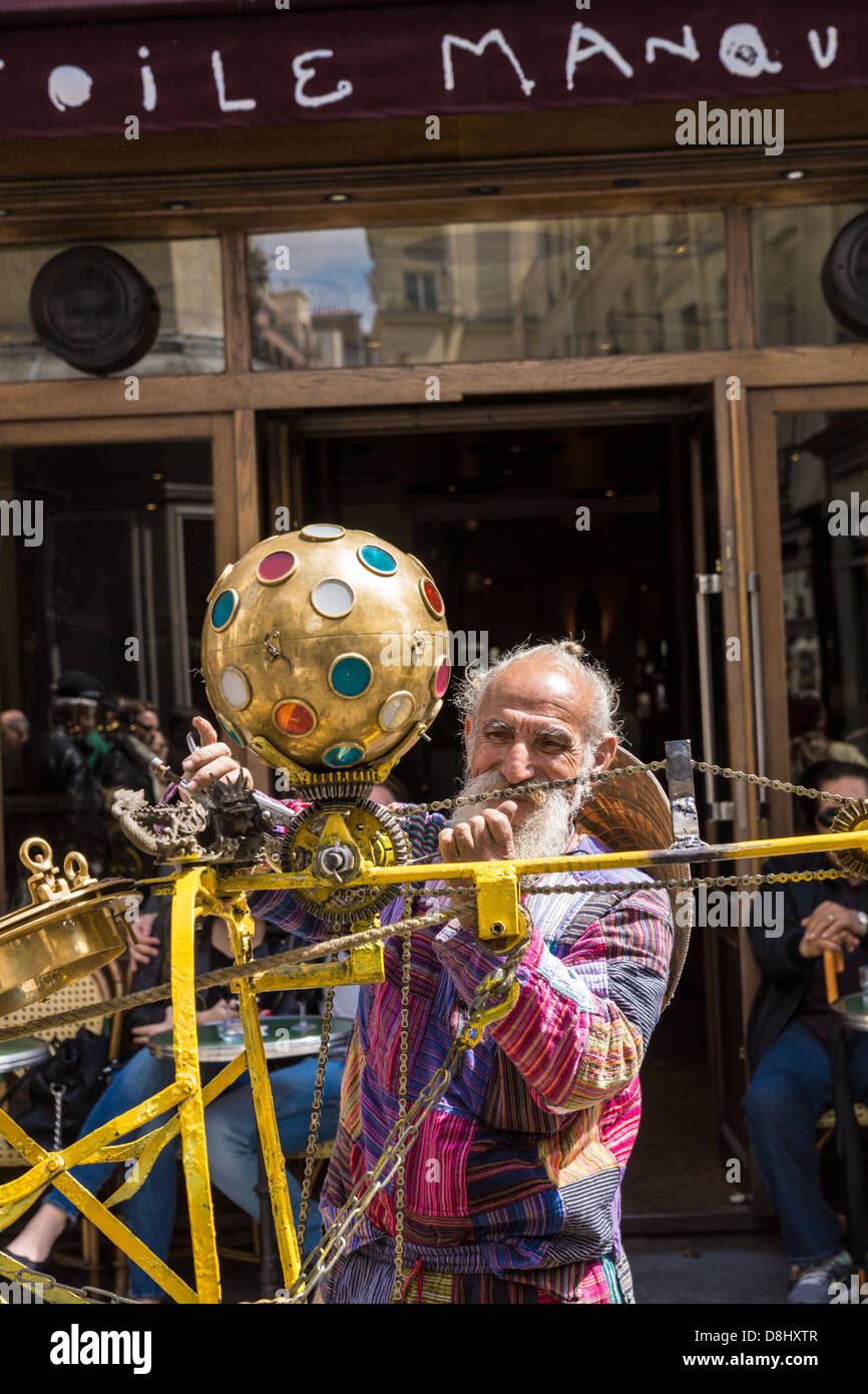 Paris,France. A colorful man works on his rickshaw with devices ...