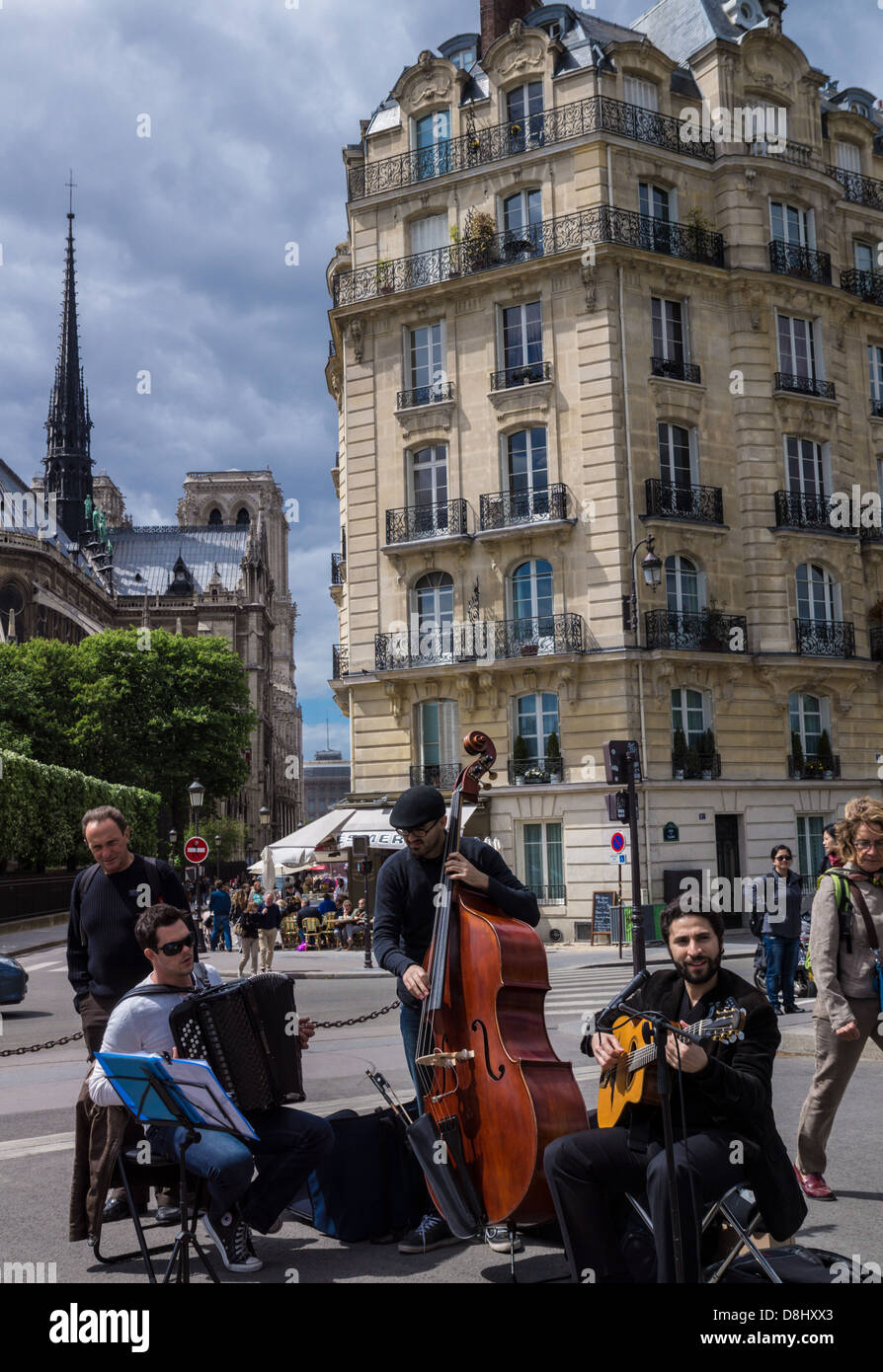 Paris, France. A Jazz band plays on the street. The towers of the ...