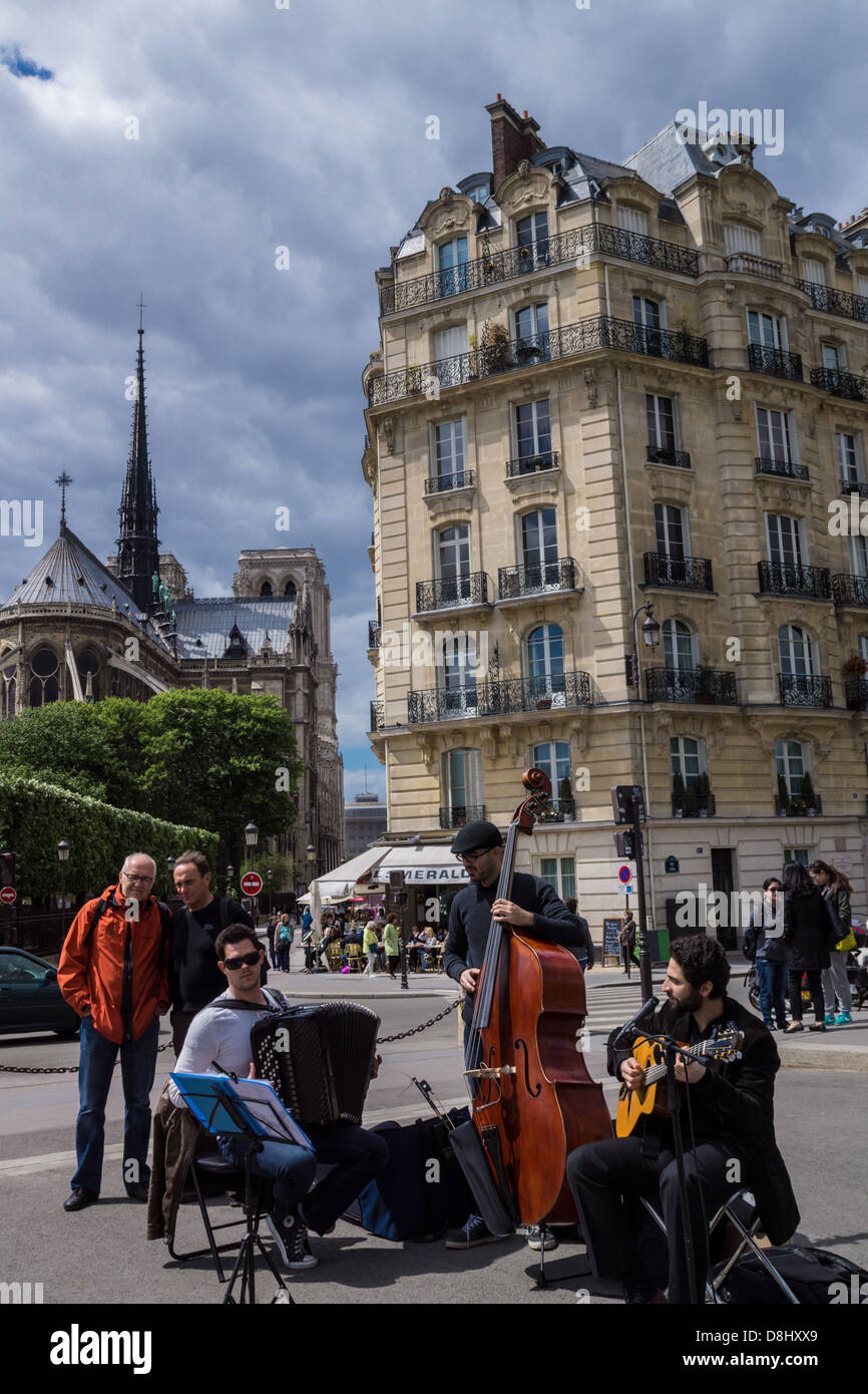 Paris, France. A Jazz band plays on the street. The towers of the ...