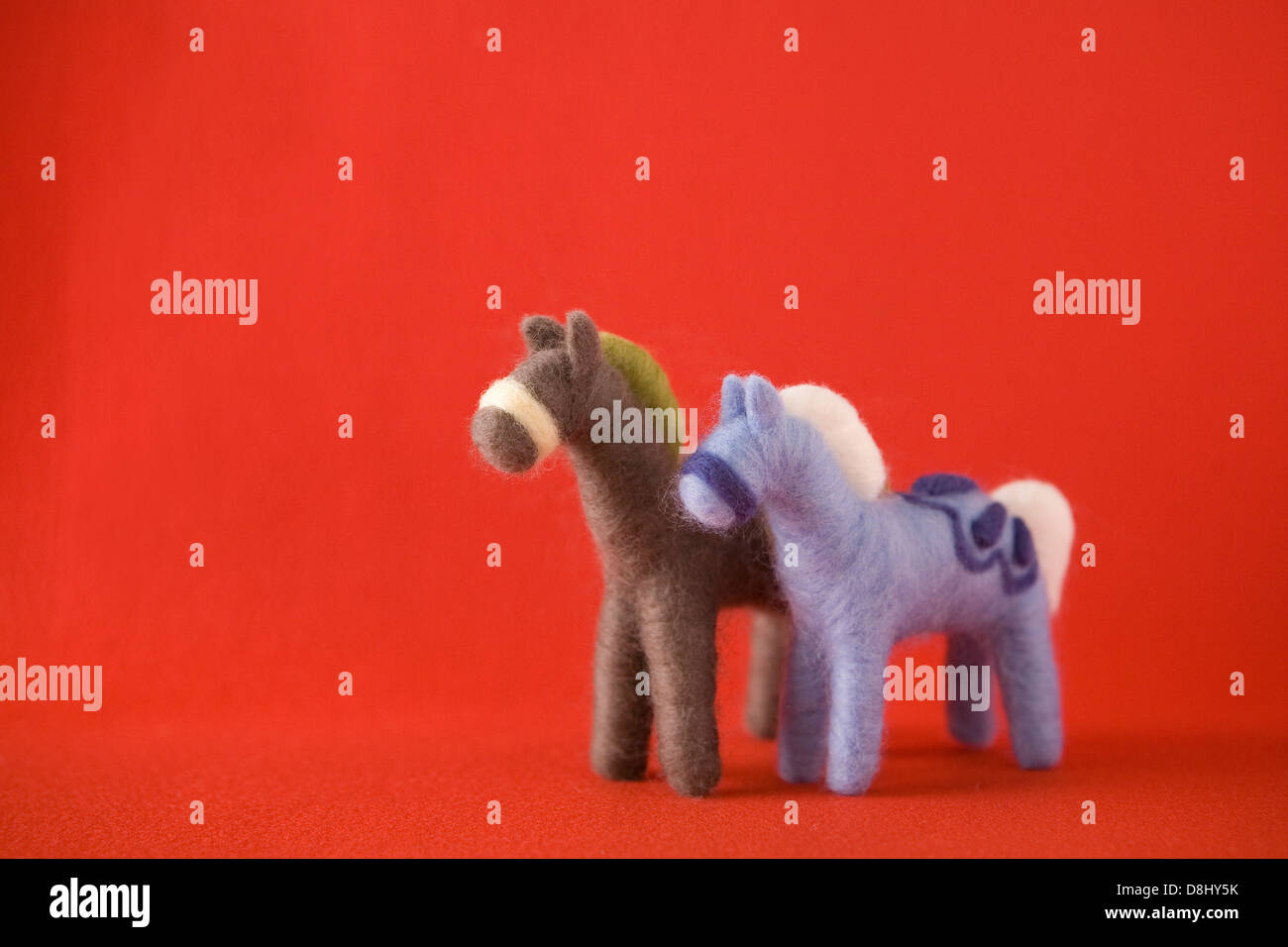 Two Felt Toy Horses on Red Paper Stock Photo - Alamy