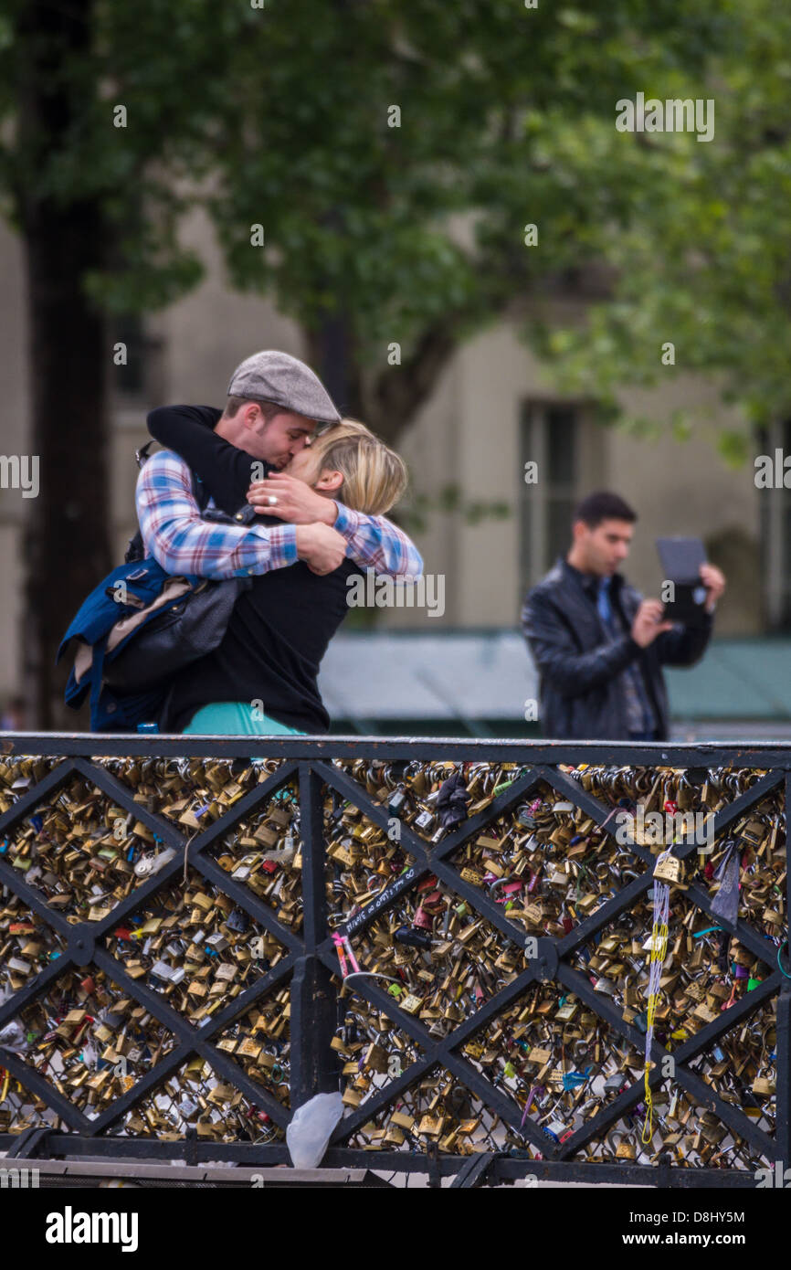 Paris, France. A Couple hugs and kisses on the Pont de l'Archevêché ...