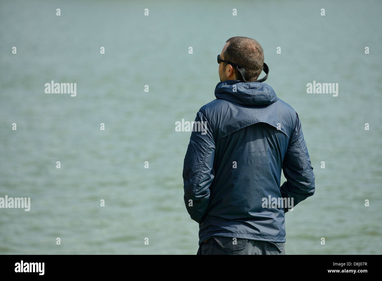 Man standing, looking into distance Stock Photo - Alamy