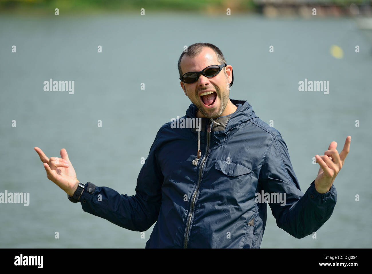 A man displaying a winning hand gesture Stock Photo - Alamy