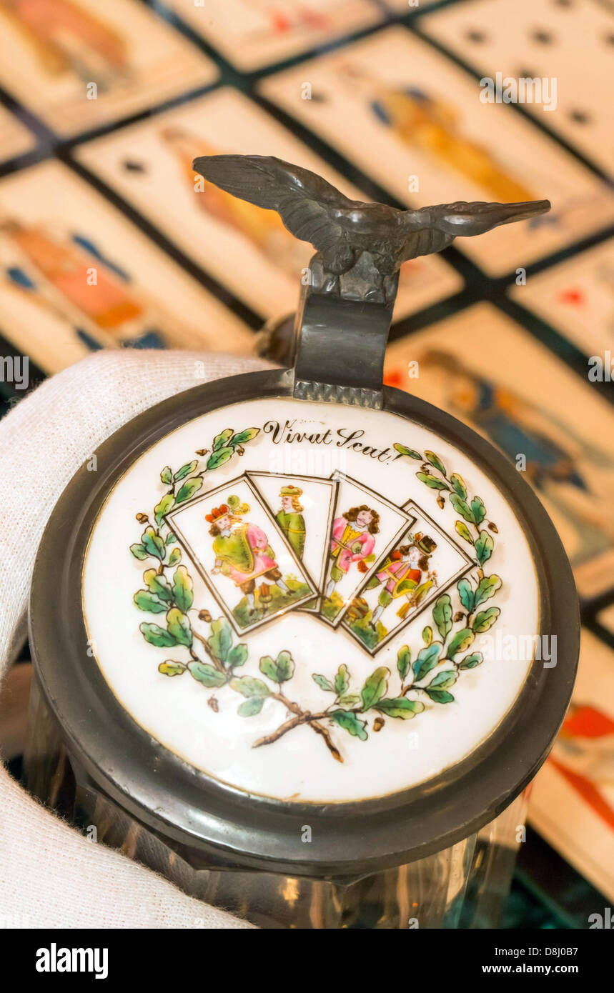 A museum employee holds a beer stein from 1893 reading "Viva Scat" in ...