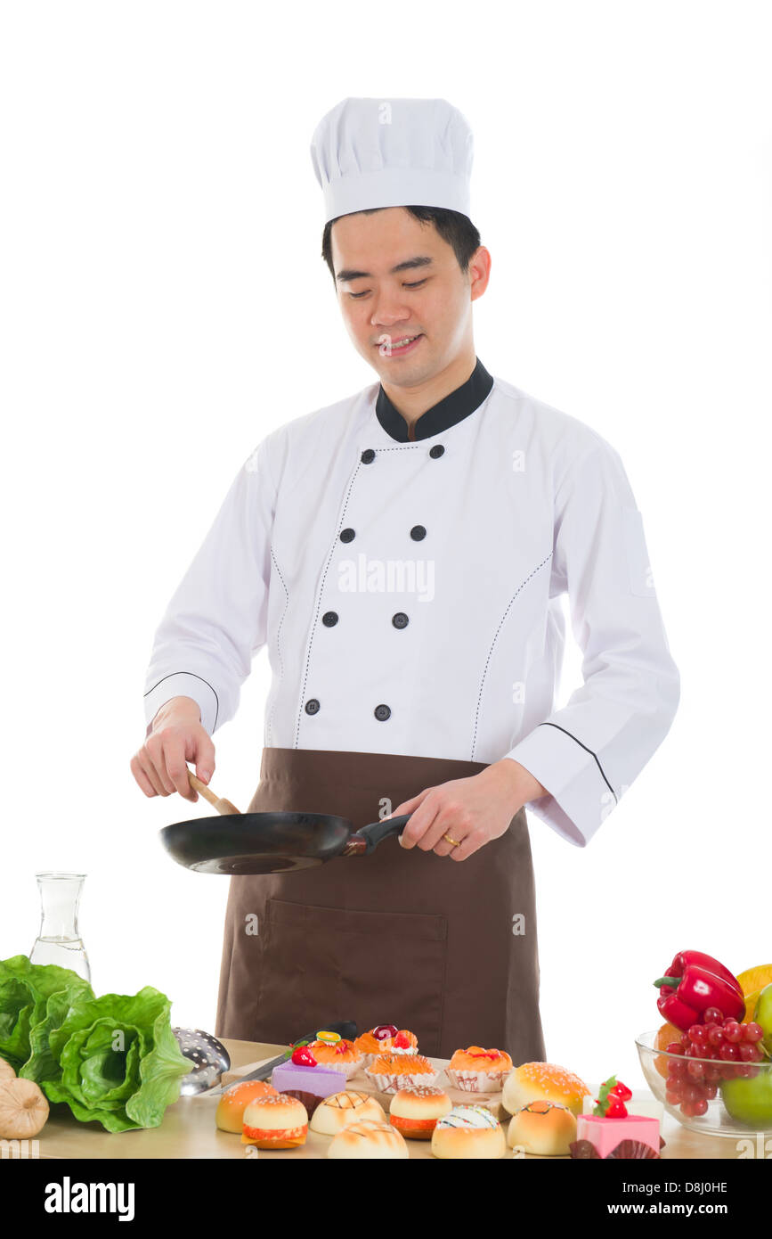 good looking asian chinese chef preparing foods for his customer with ...