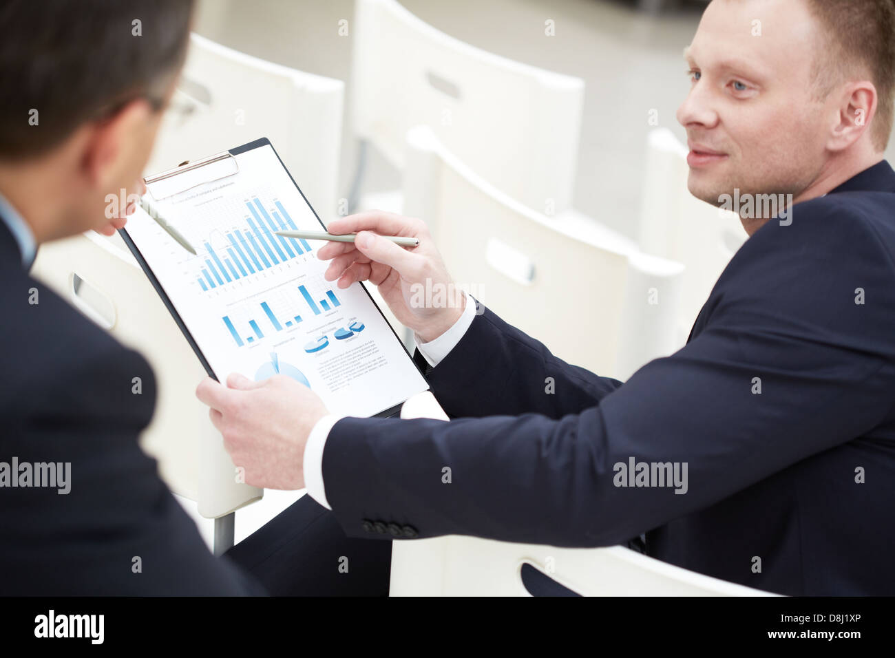 Two businesspeople discussing graph hi-res stock photography and images ...