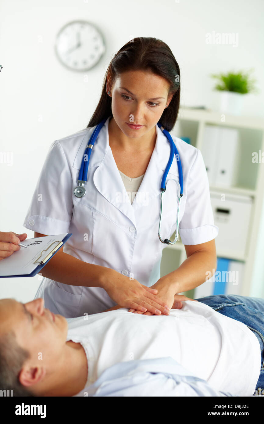 Portrait of confident female doctors during medical treatment of ...