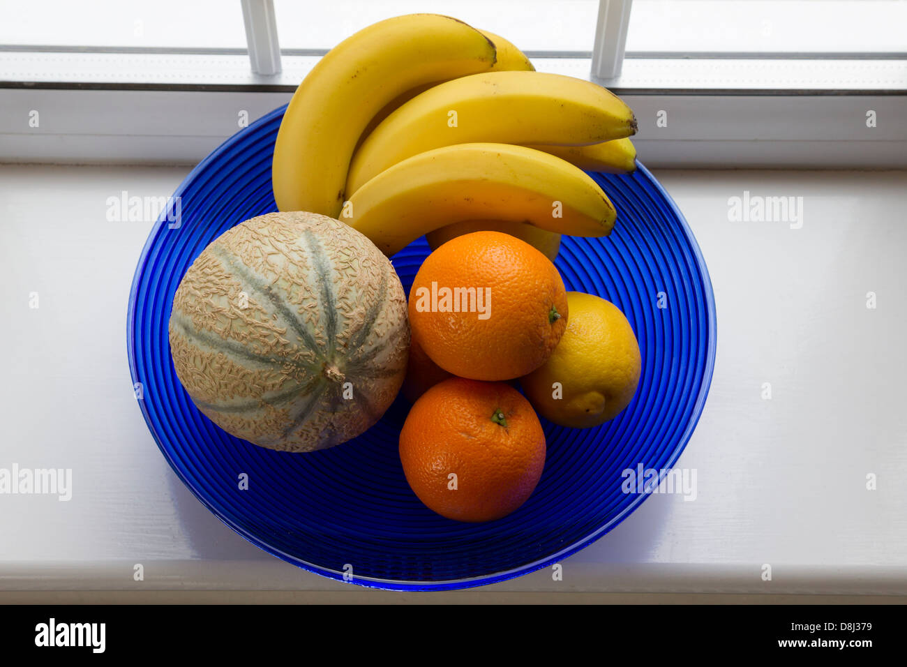 Bowl of fruit on a window ledge Stock Photo - Alamy