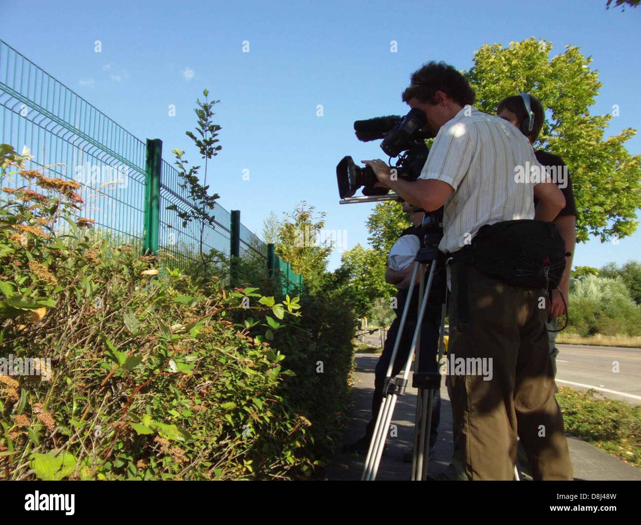 A film crew in action on set, capturing the process of making a movie ...