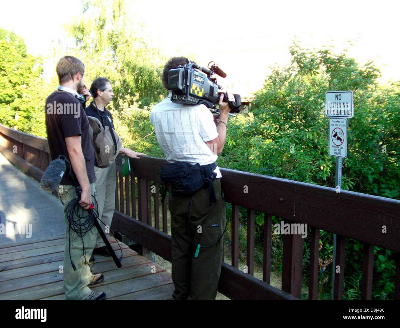 A film crew is seen working on location, with cameras, lights, and ...