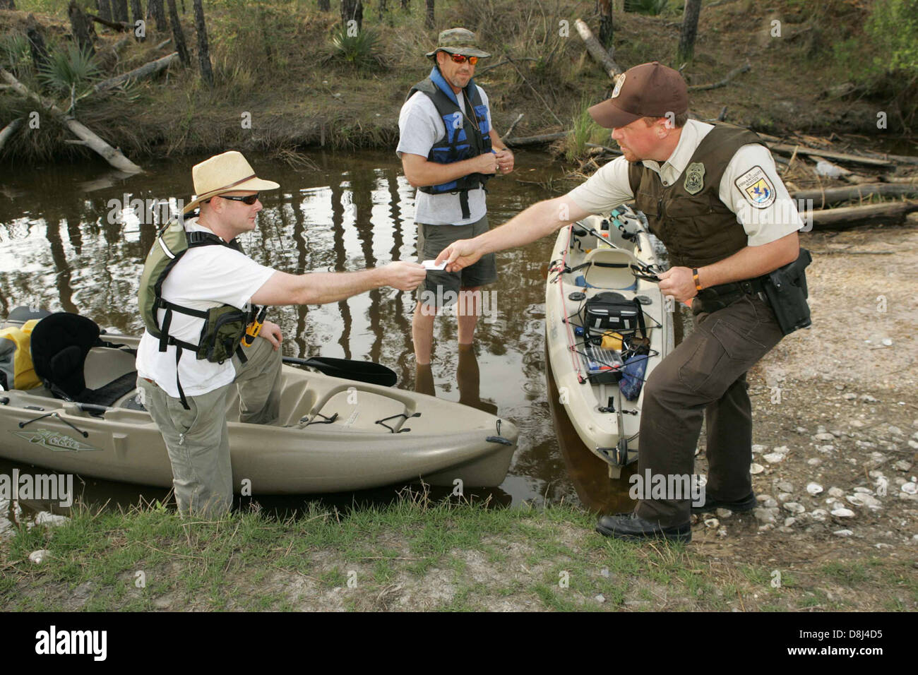 This image depicts a fishing licence compliance check, where ...