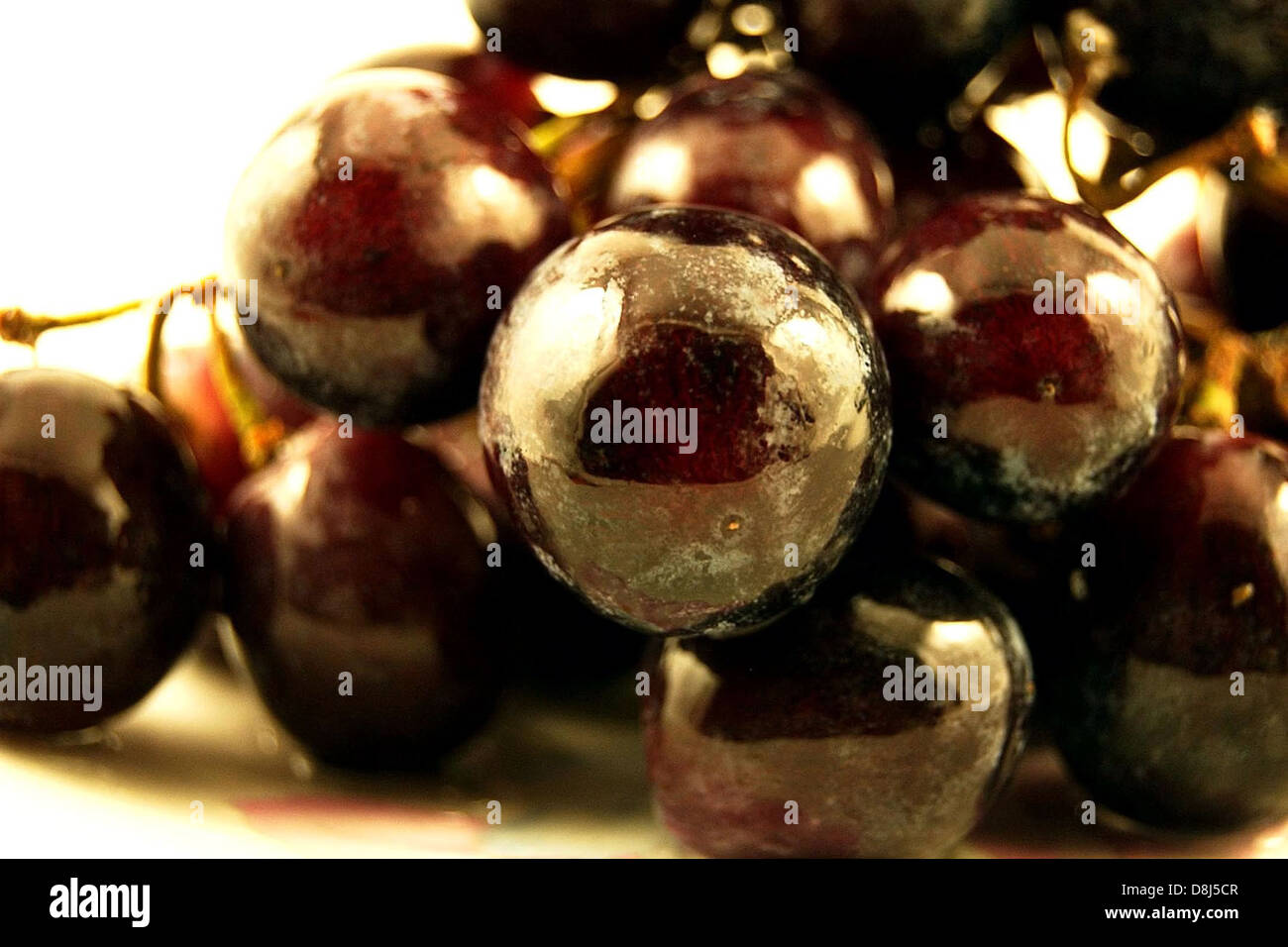 A variety of fresh fruits and vegetables, including grapes, arranged ...