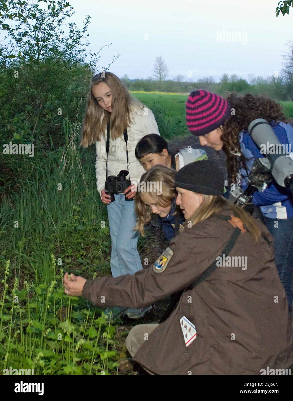 A group of Girl Scouts participating in outdoor activities in a natural ...