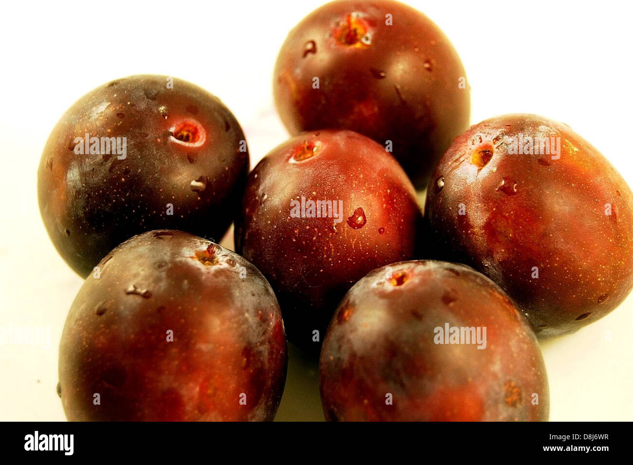 A cluster of grapes, showcasing its small round shape and rich color ...