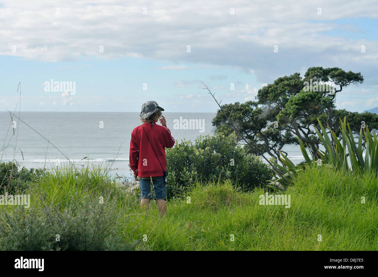 Boy watching ocean Stock Photo - Alamy