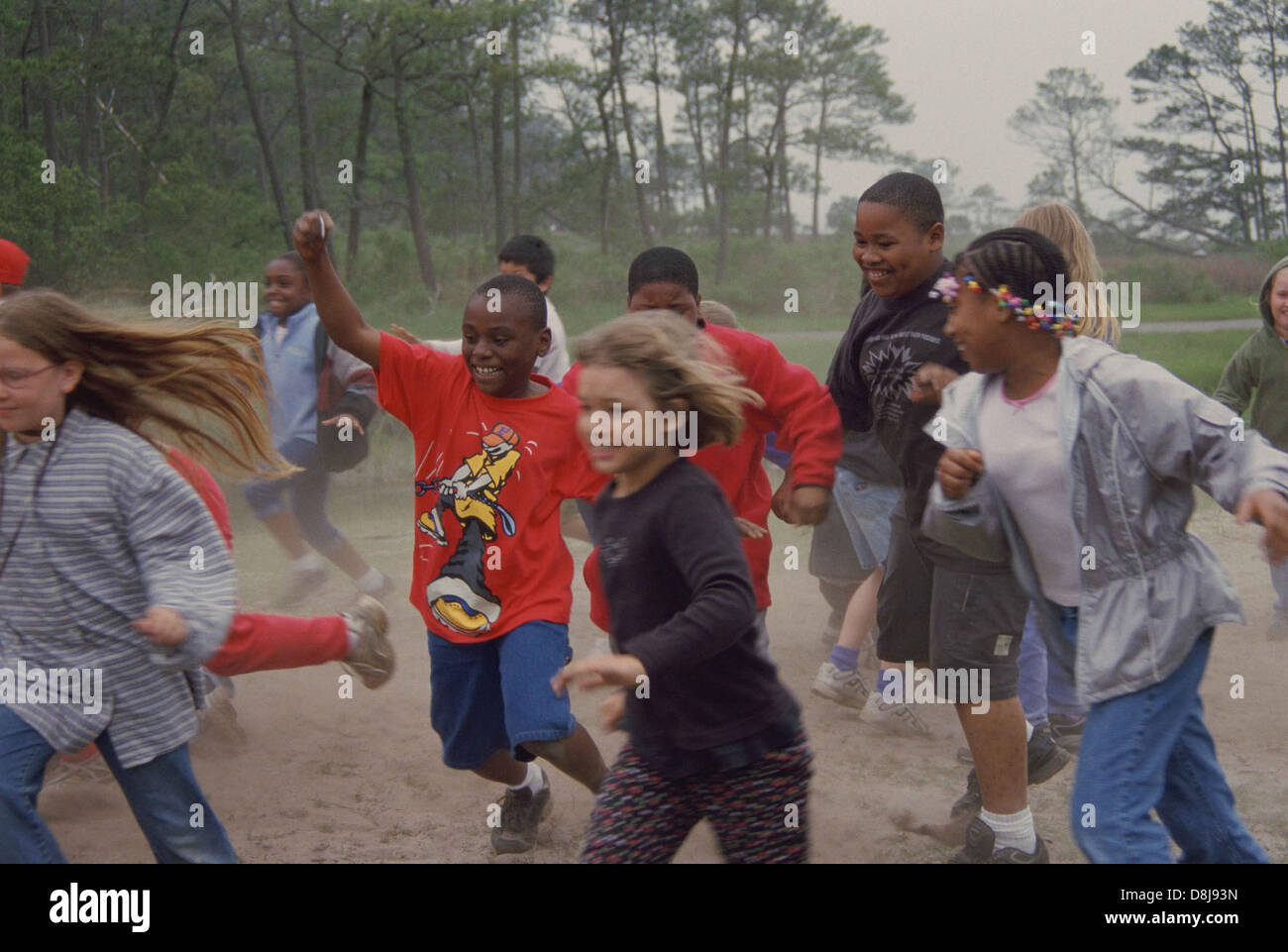 Happy group of children playing race Stock Photo - Alamy