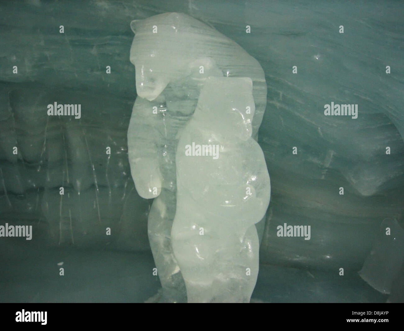 An intricately carved ice statue, shining with clarity, formed from ...