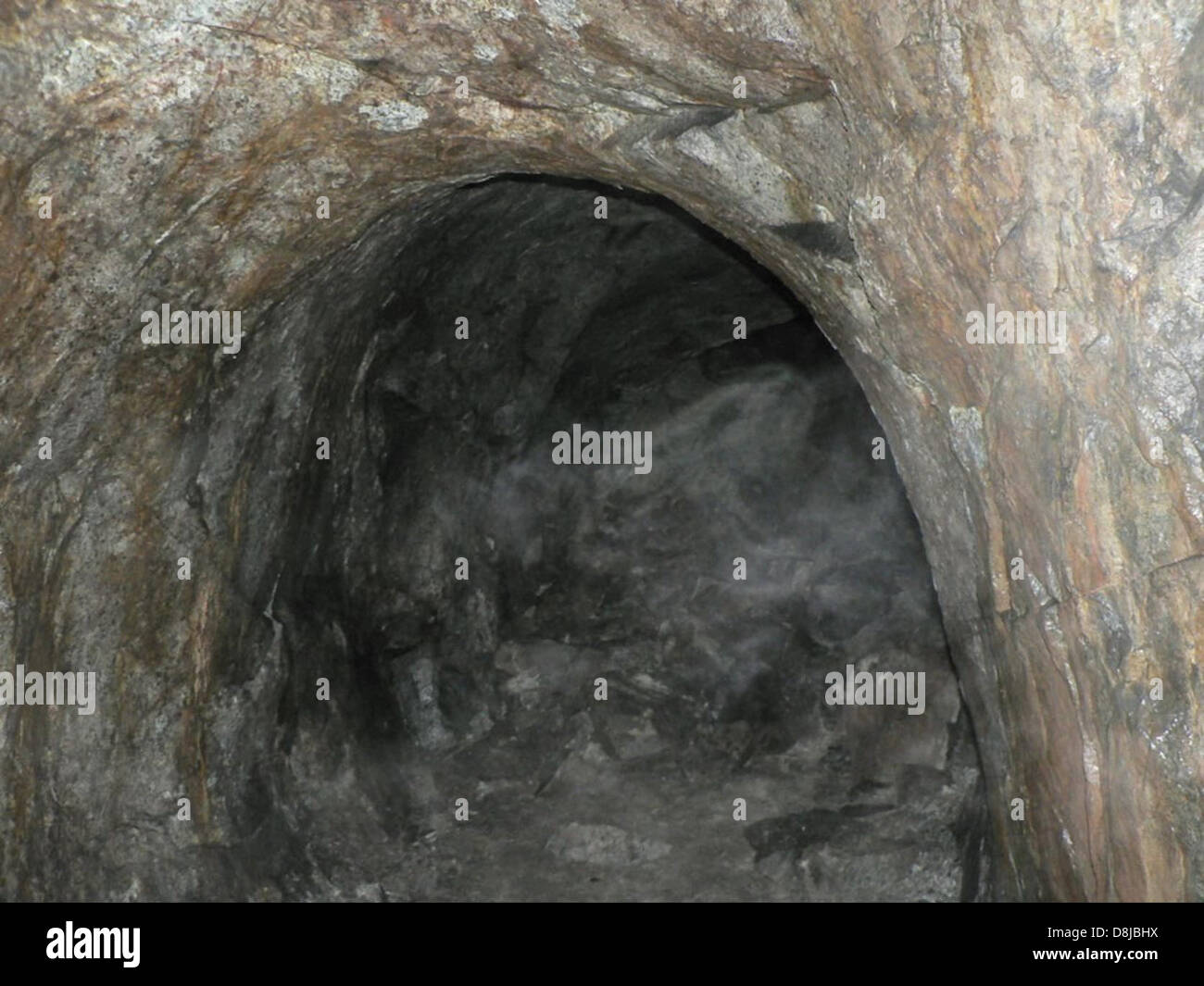 A mining path blocked by debris, creating a traffic jam of machinery ...