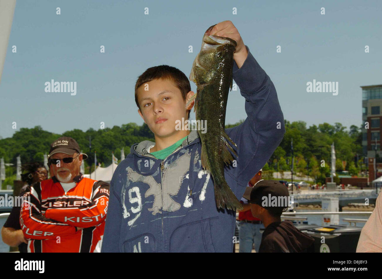Kid holds up a bass fish caught Stock Photo - Alamy