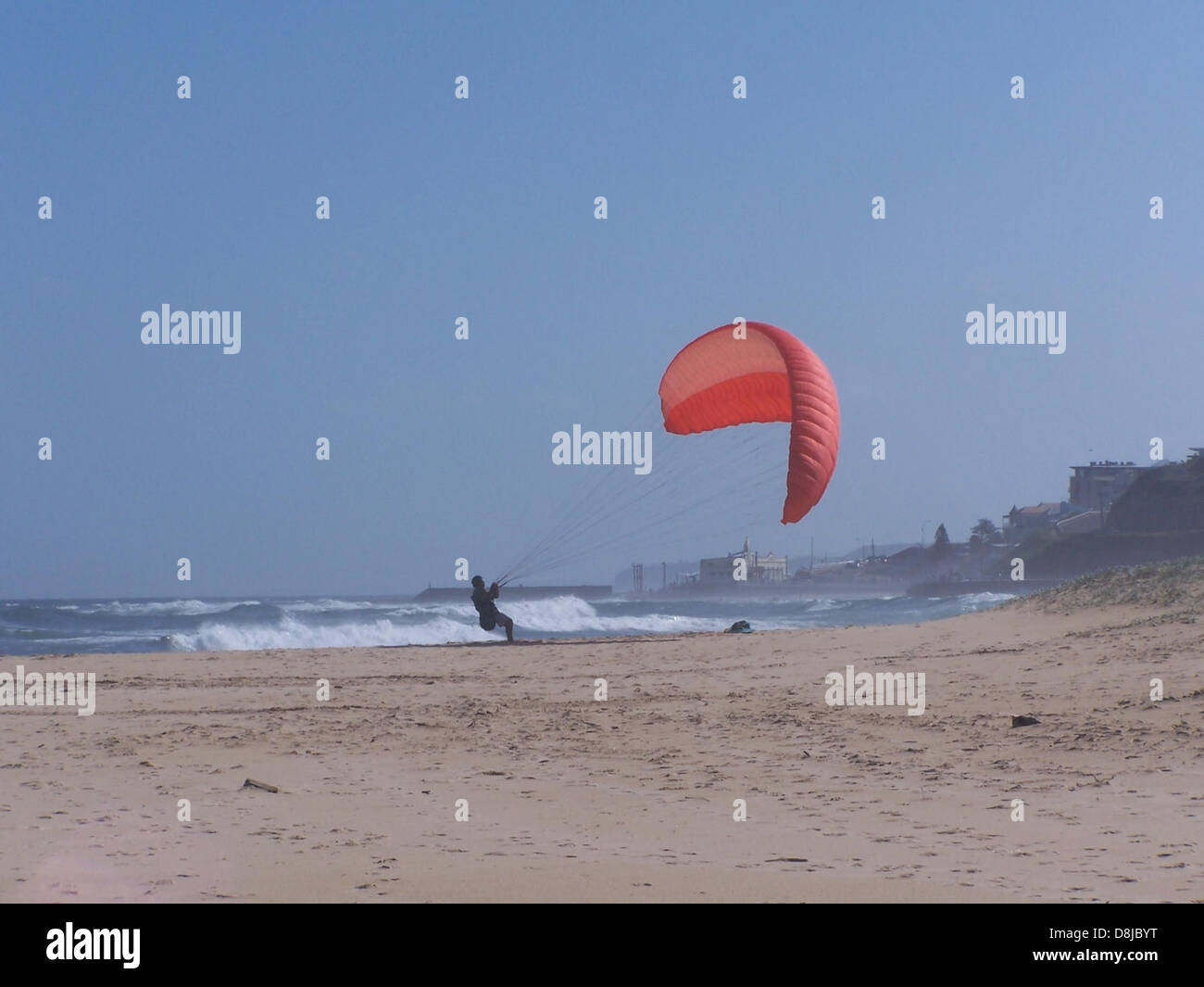 A kite soaring into the sky on a beach, catching the wind. The image ...
