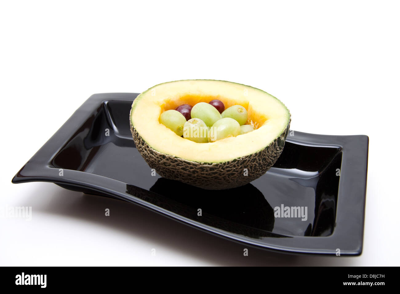 Melon with grapes Stock Photo - Alamy