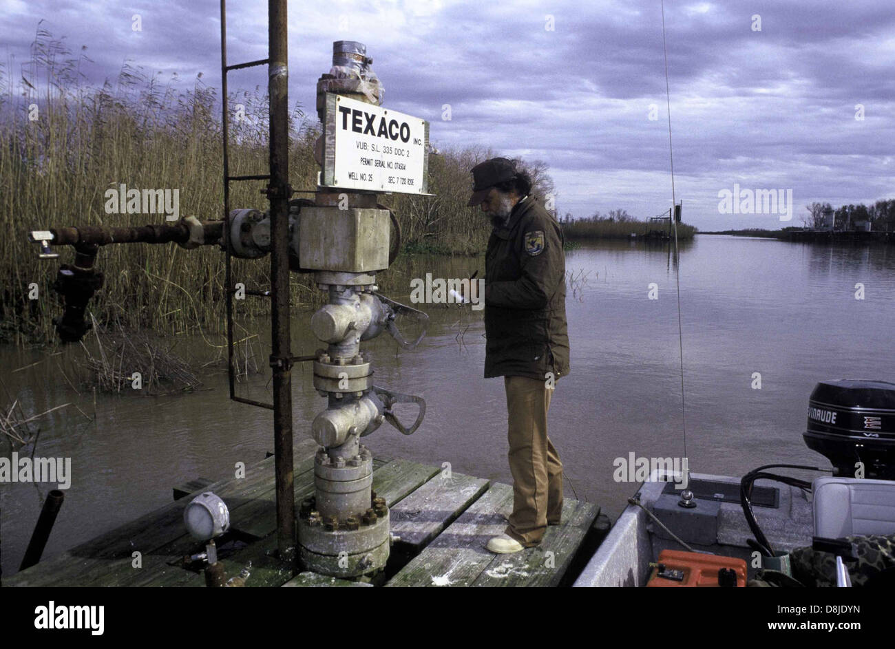 Man checking oil well Stock Photo - Alamy