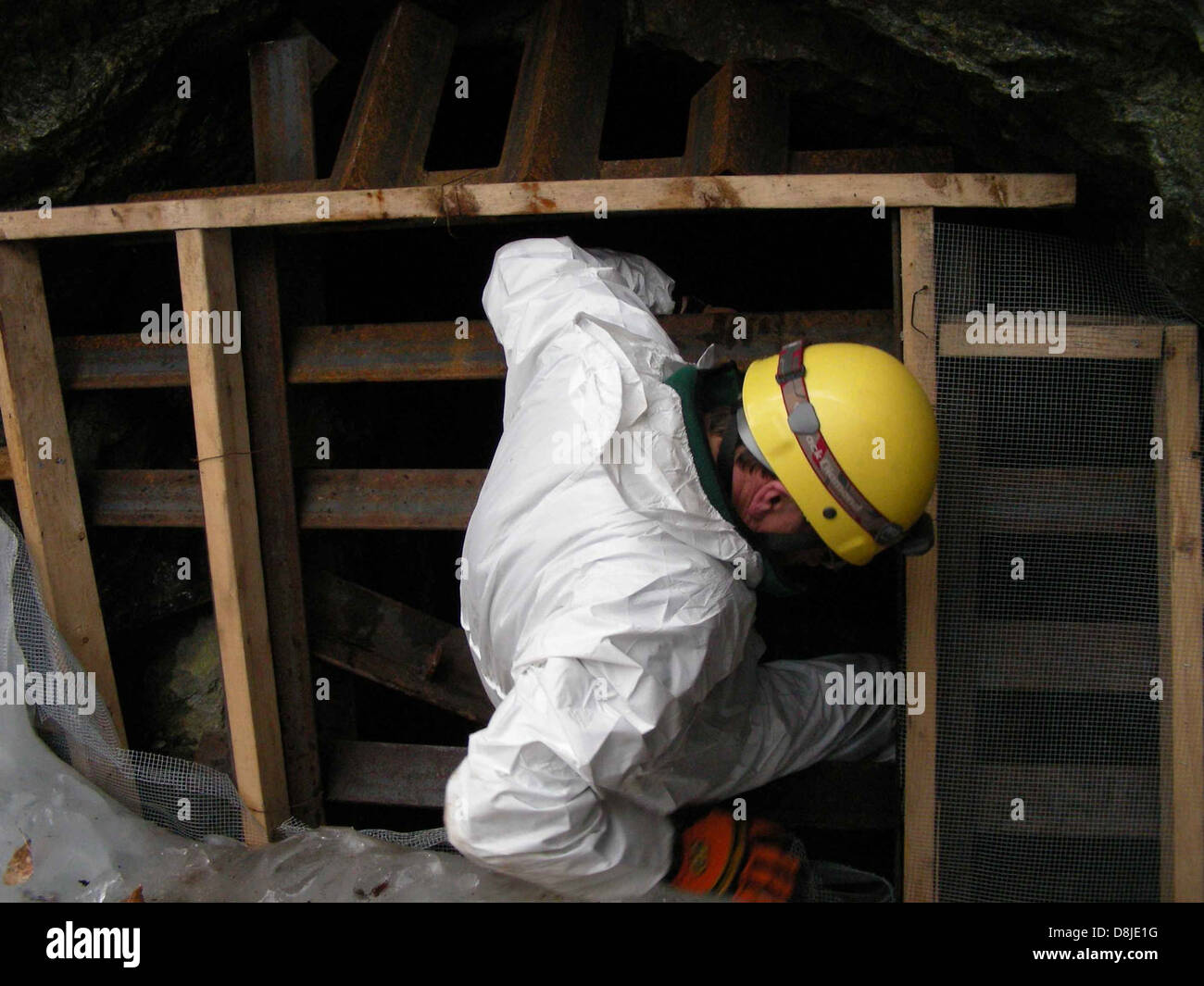 Man entering cave Stock Photo - Alamy