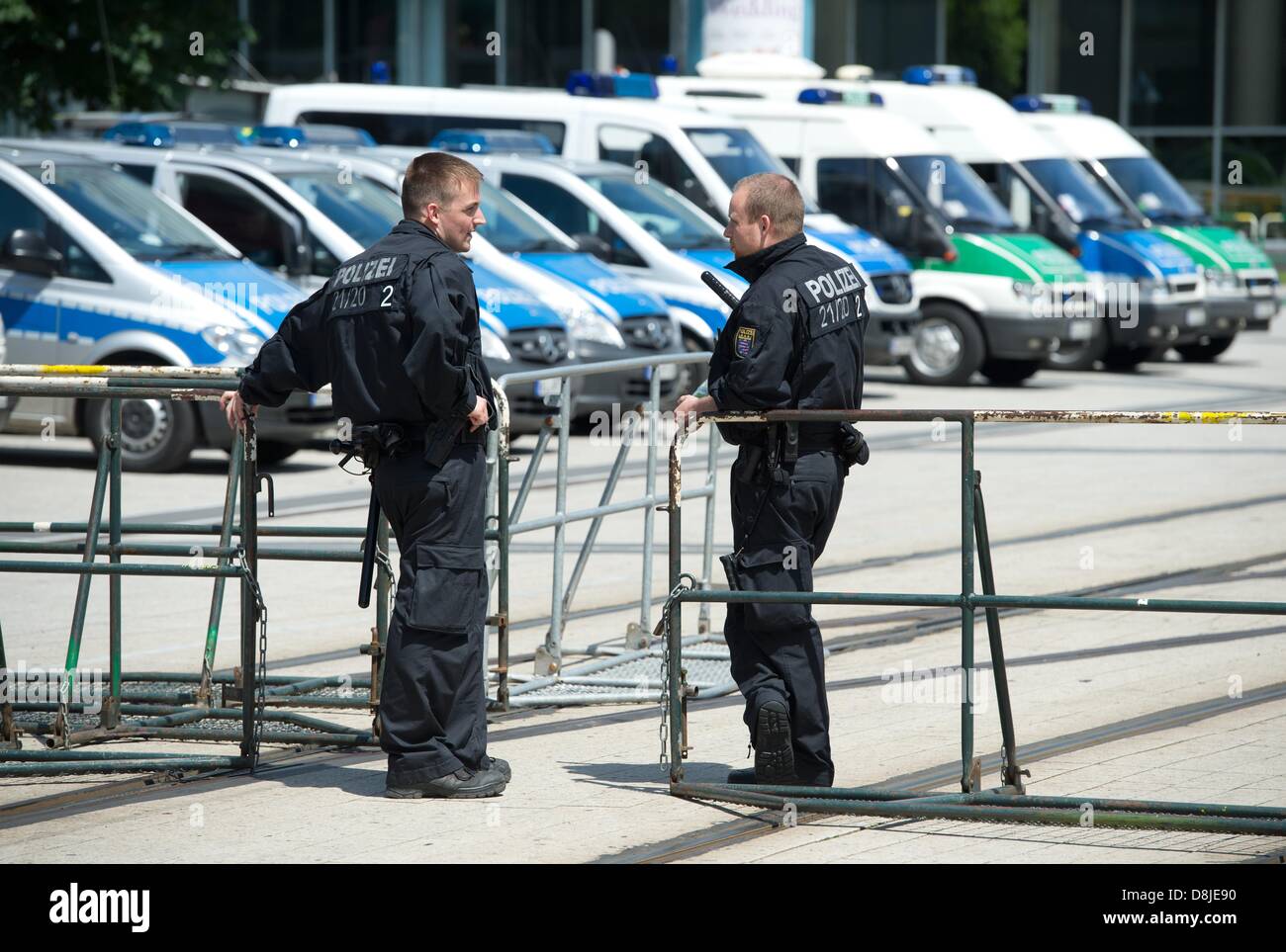Police officers stand at constructed barricades in front of the ...