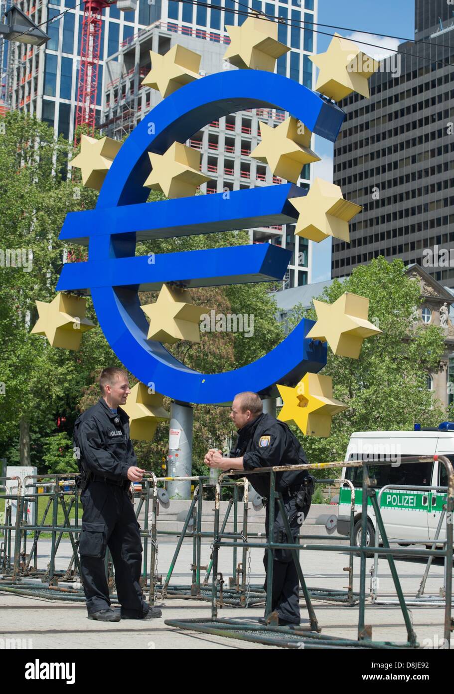 Police officers stand at constructed barricades in front of the ...