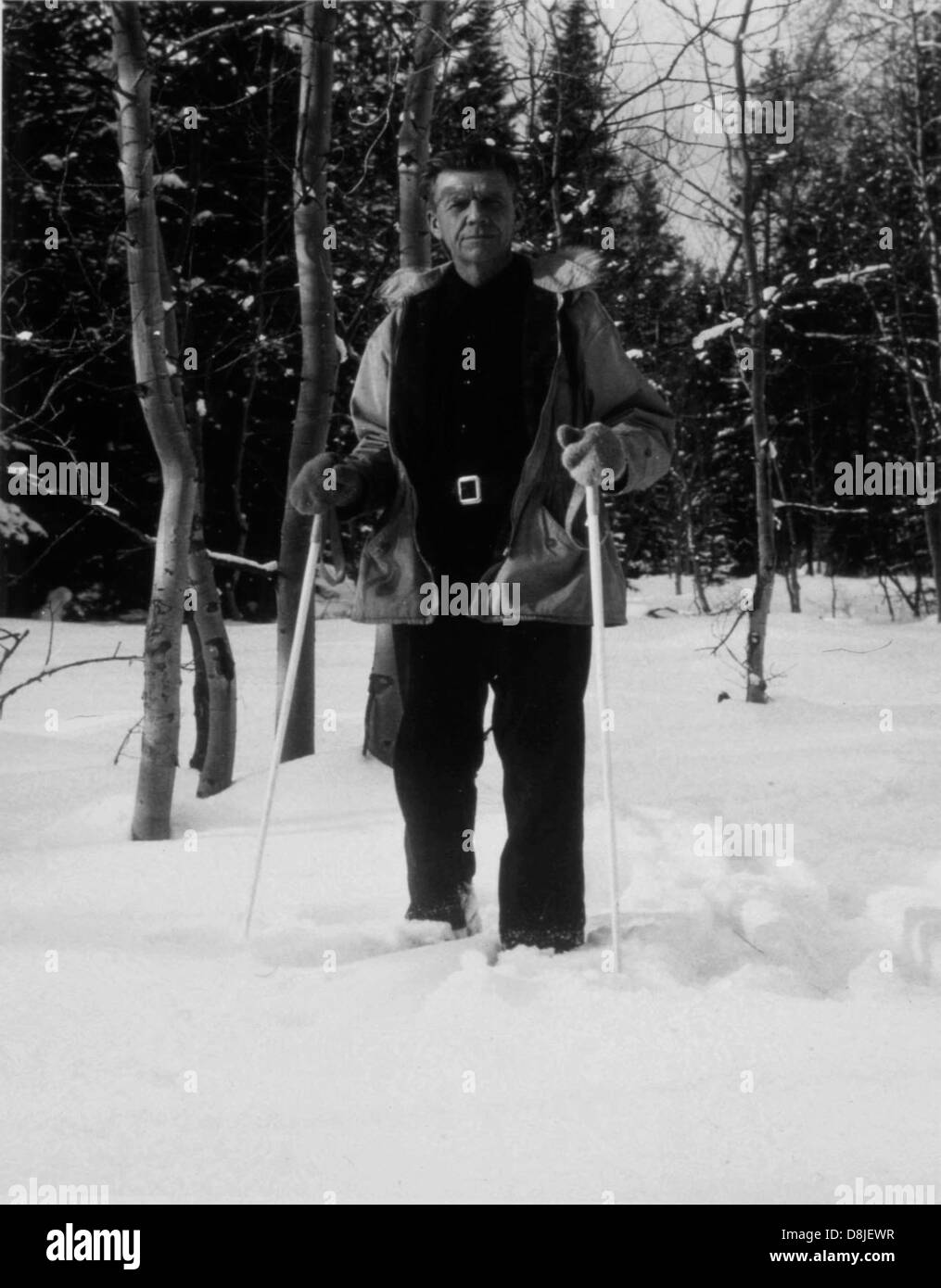 This image shows a man standing on skis in snow, likely in a winter ...