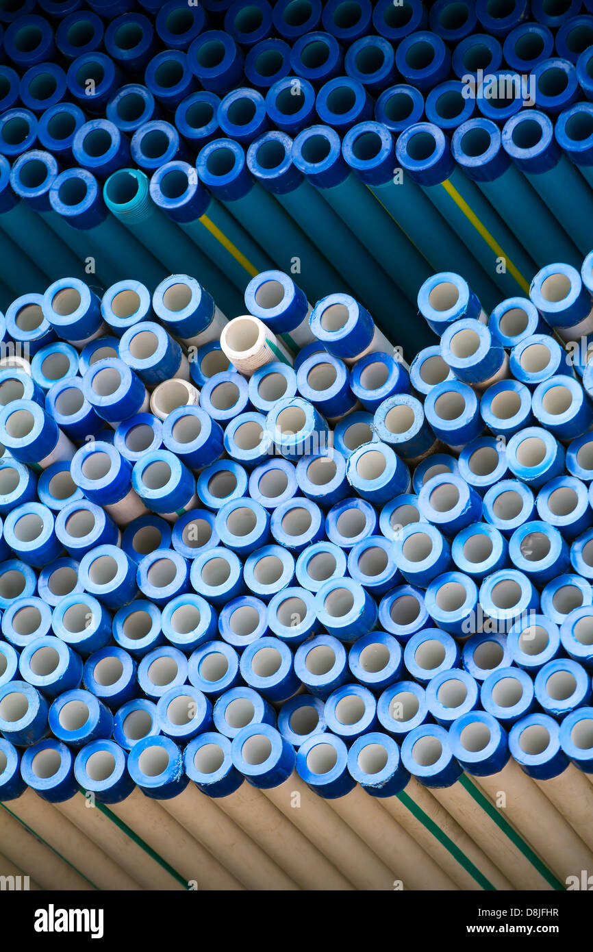 Stacked plastic pipes and tubes background Stock Photo - Alamy