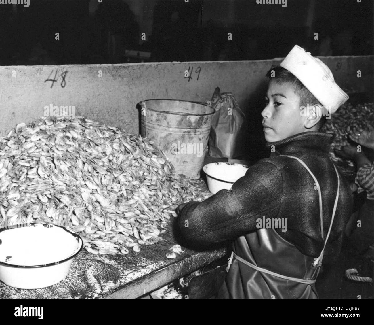 Native Alaskan boy working in fish house Stock Photo - Alamy