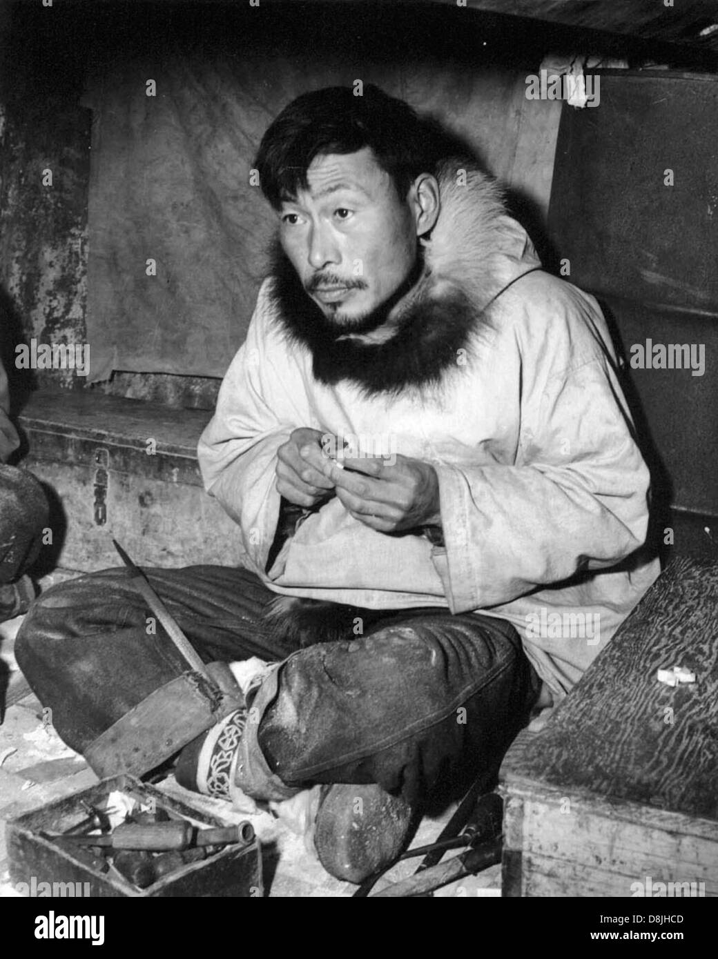 A portrait of a Native American man, dressed in traditional attire. The ...