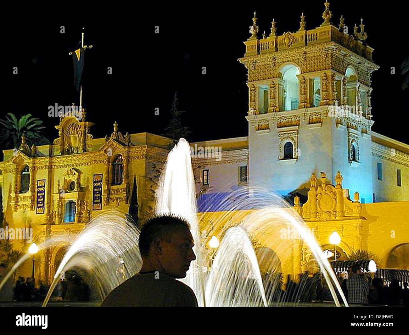 A night scene featuring illuminated fountains with water cascading down ...