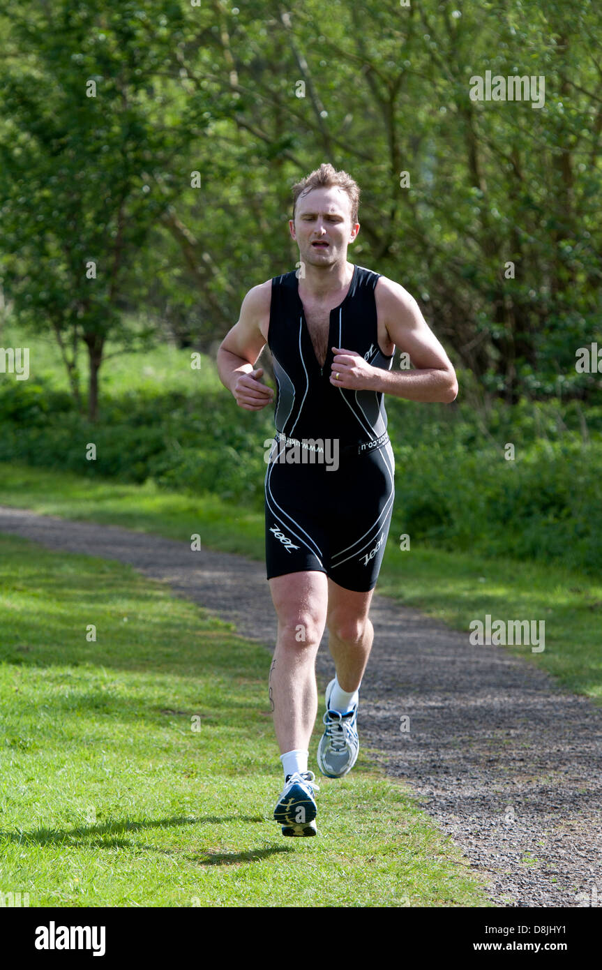 Man running in 2013 Stratford 220 Triathlon Stock Photo - Alamy