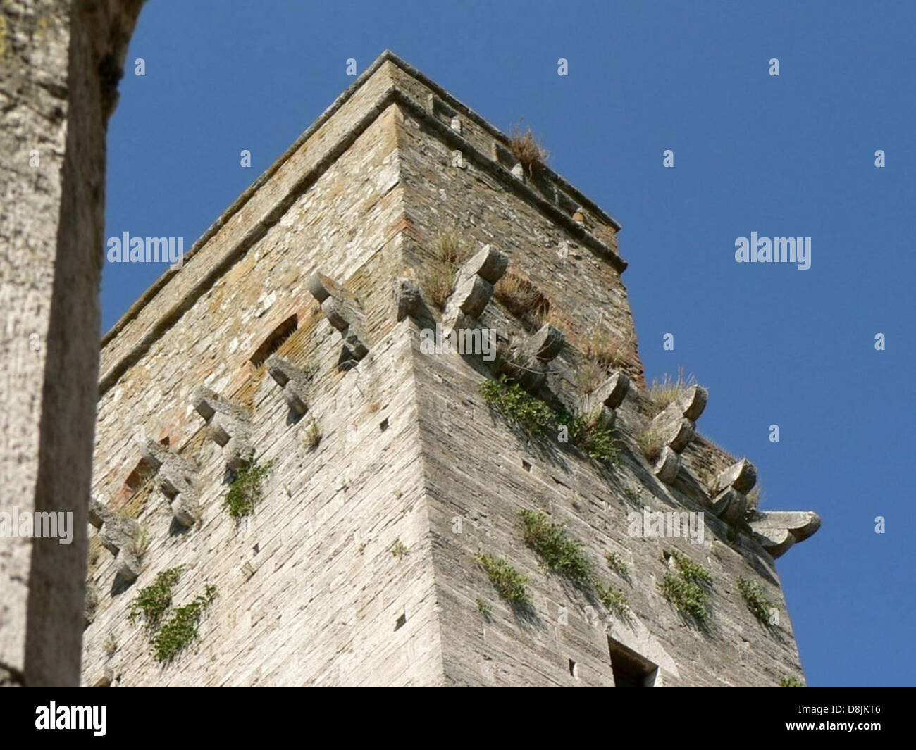 An ancient tower stands in the center of a small village, with its ...