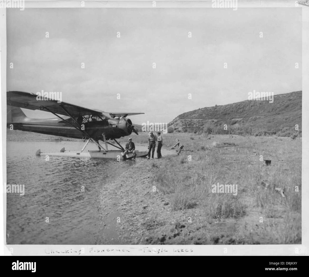 An old vintage photograph featuring a water plane and people, likely ...