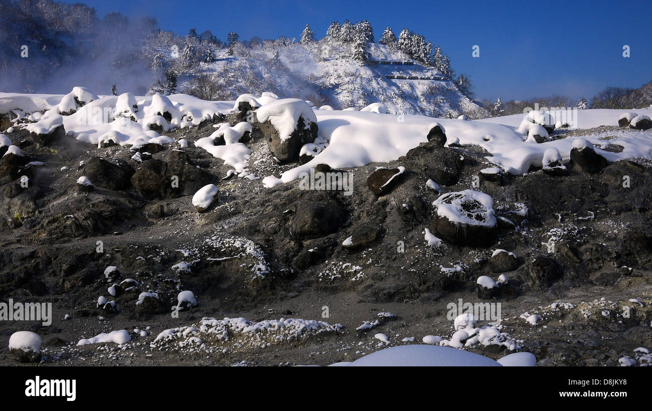 Heated spots at Tamagawa Onsen melting the snow away exposing dark ...