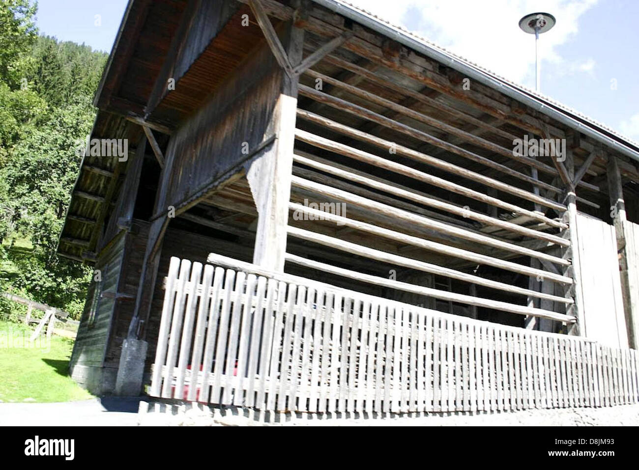 This image shows an old wooden mill, showcasing its time-worn structure ...