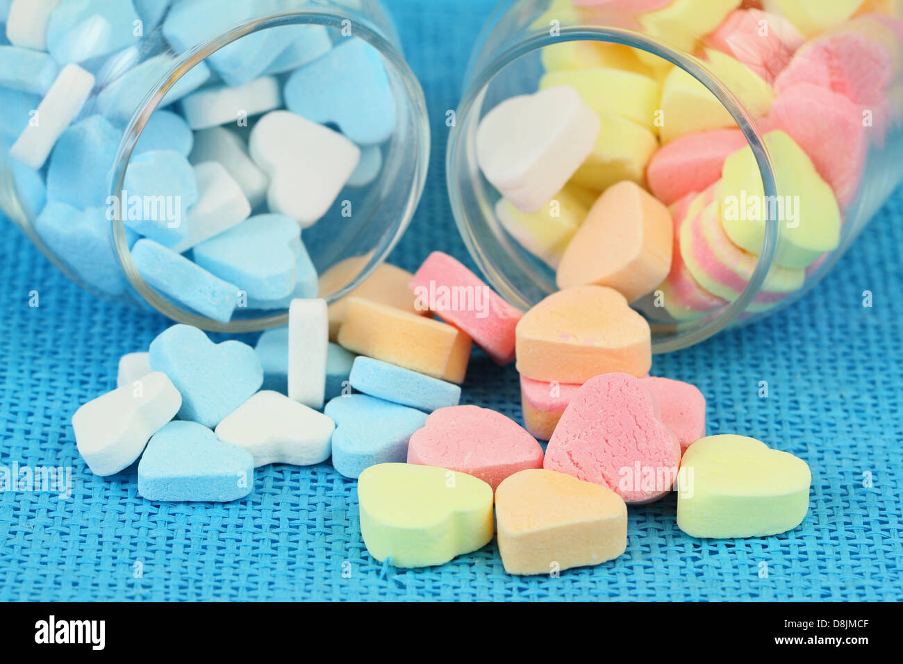 Colorful sugar hearts in transparent bottles, close up Stock Photo - Alamy