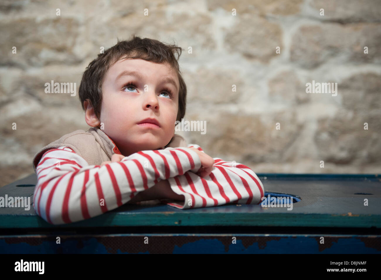 Boy looking up in thought Stock Photo - Alamy