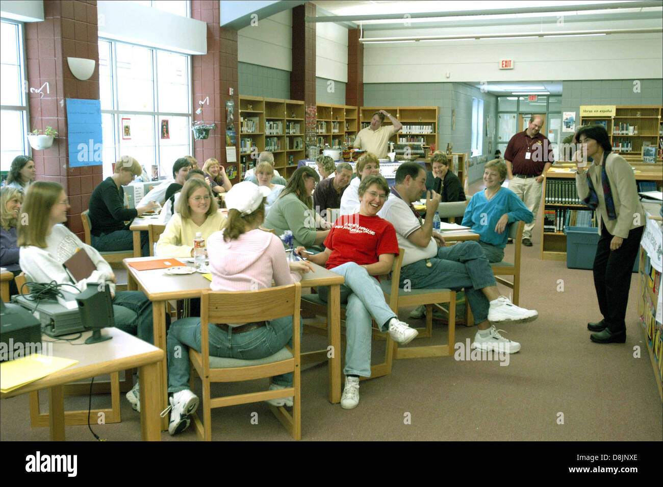 A group of people participating in a workshop class, actively engaging ...