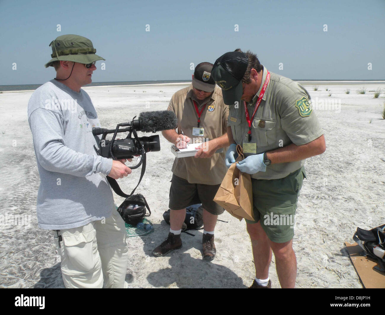 A group of people on an open field or outdoor location taking data. One ...